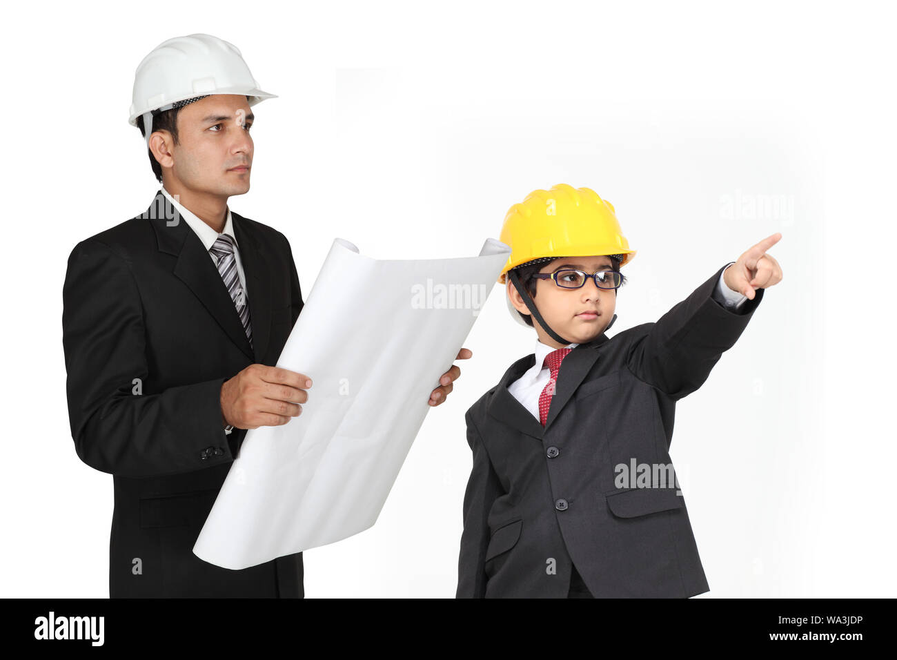 Boy imitating as architect and standing with his father Stock Photo - Alamy
