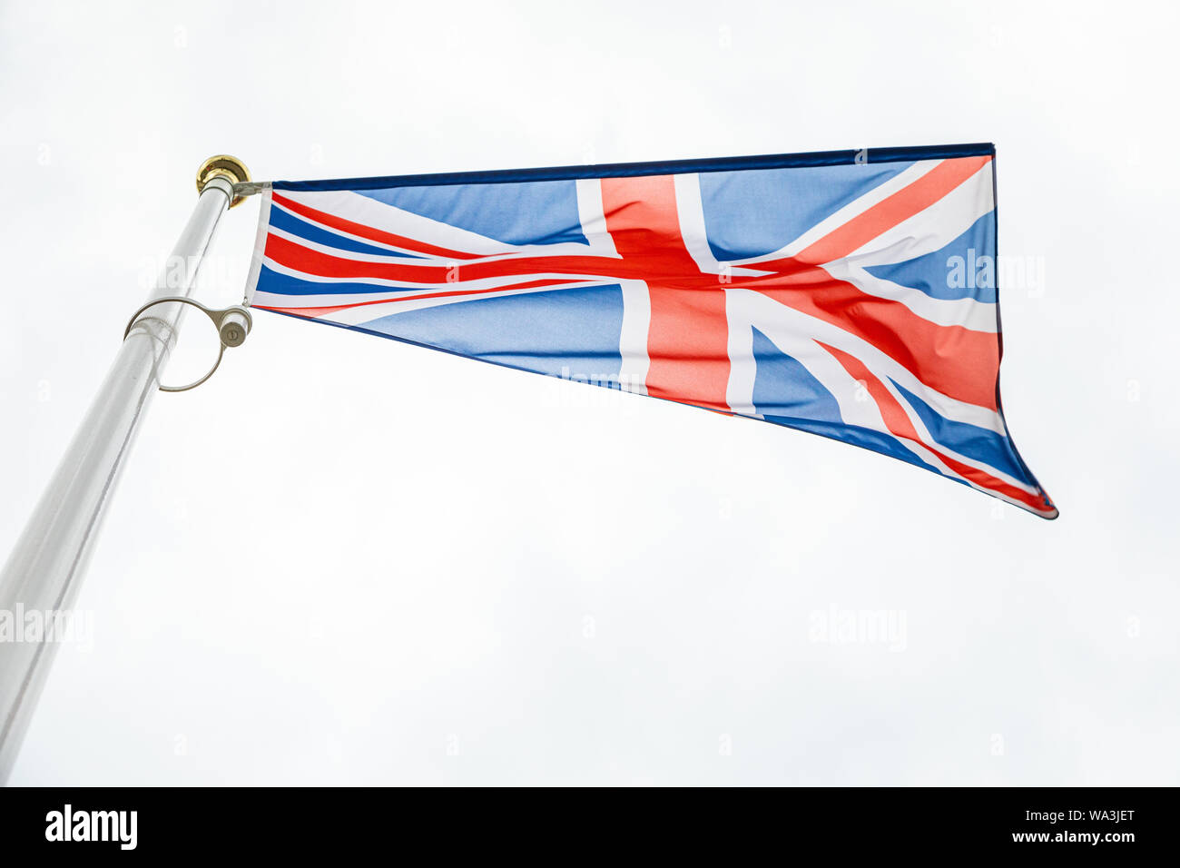 flag of the UK on a flagstuff in front of the sky Stock Photo - Alamy