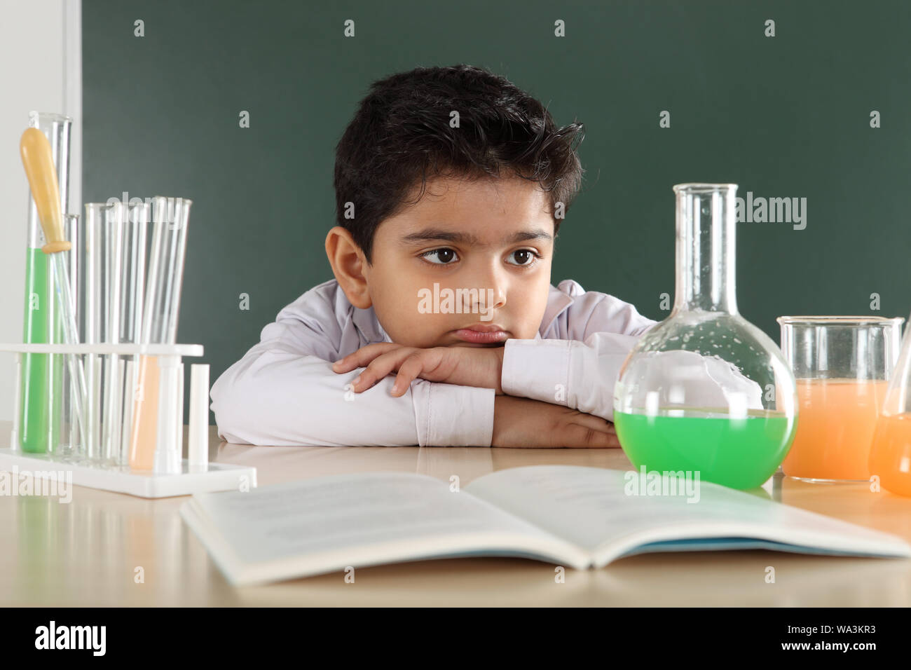 Schoolboy looking sad in a chemistry lab Stock Photo - Alamy