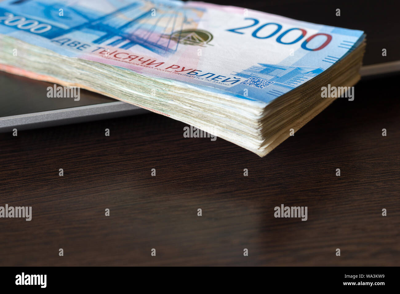 Payments for computer work concept. Stack of russian rubles lay on ...