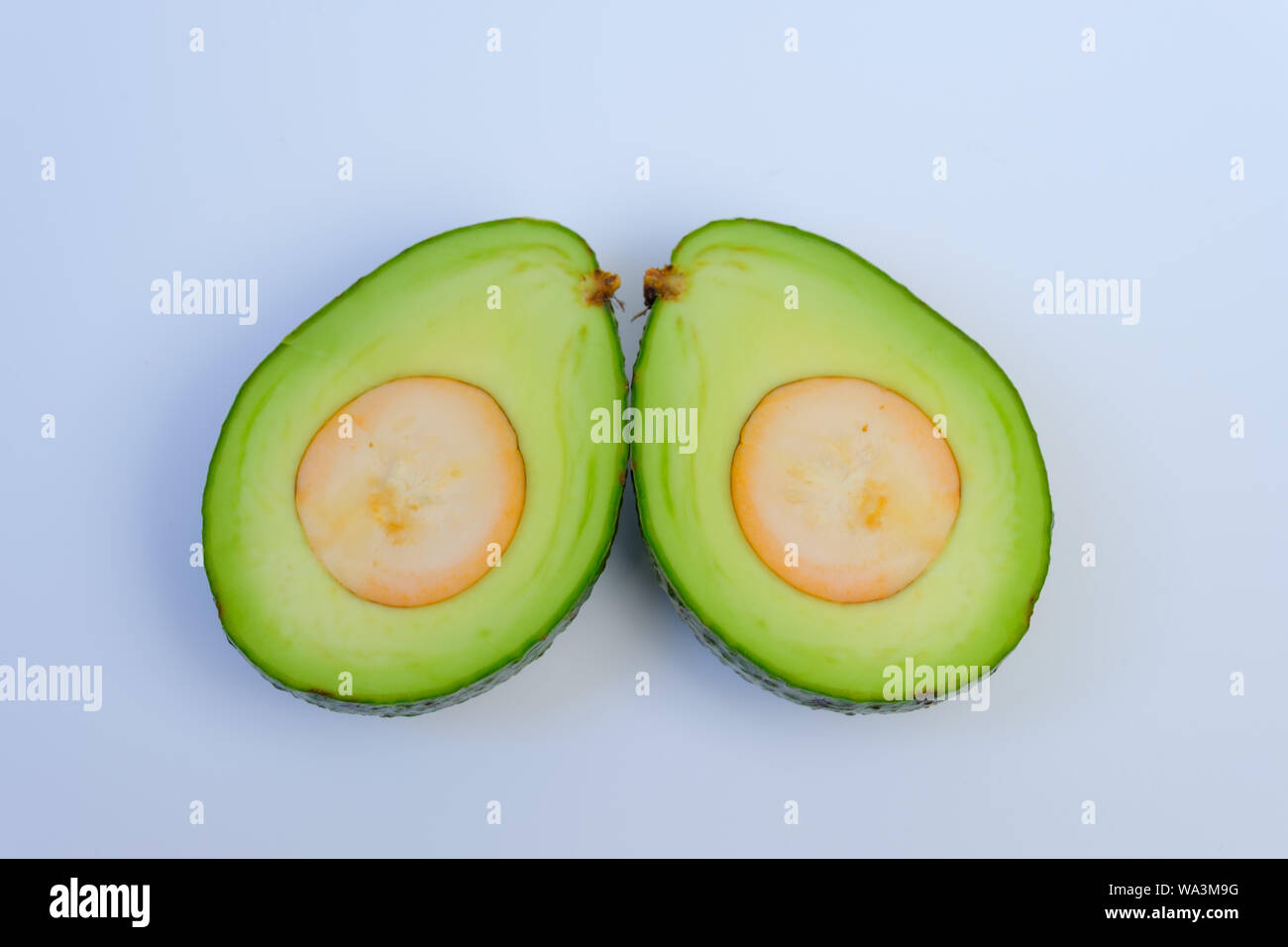 In this photo you can see a piece of avocado split into two halves ...