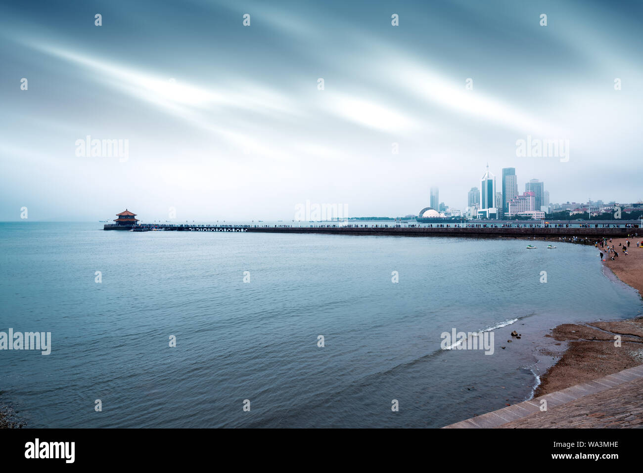 The trestle bridge by the sea, the Qingdao city landscape in the fog ...