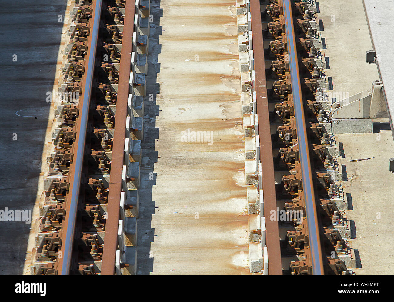 High angle view of metro rail tracks on concrete under sun. Details of ...