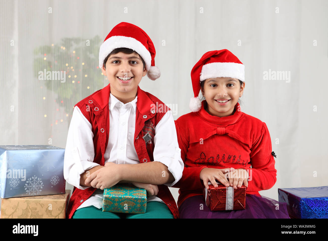 Two children celebrating Christmas Stock Photo - Alamy