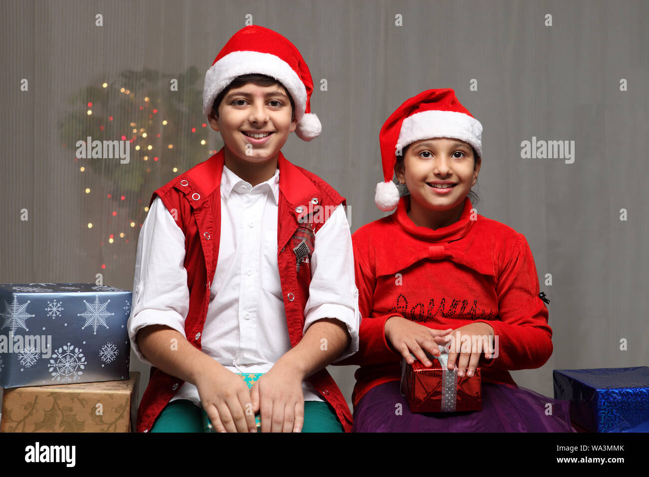 Two children celebrating Christmas Stock Photo - Alamy