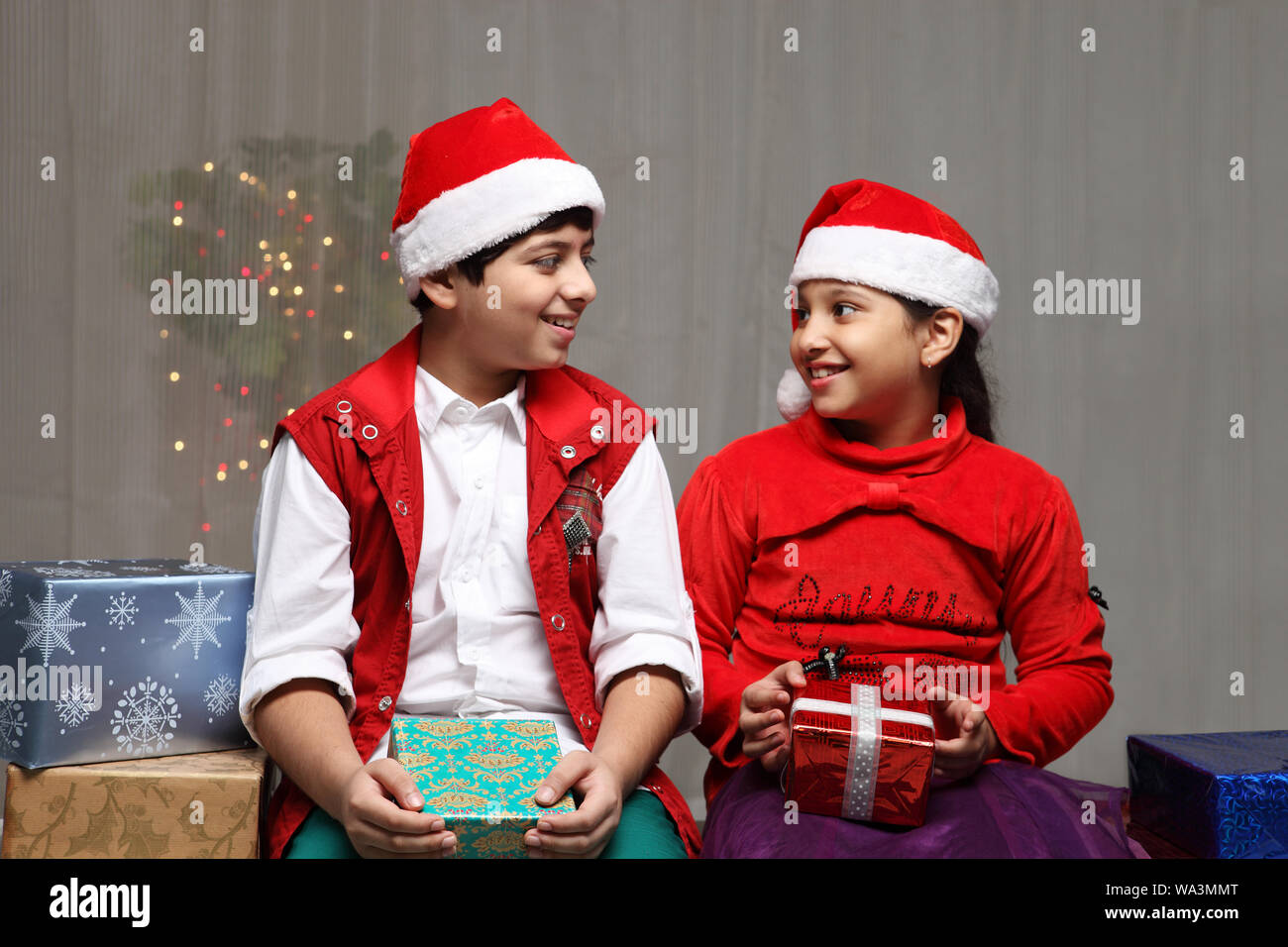 Two children celebrating Christmas Stock Photo - Alamy