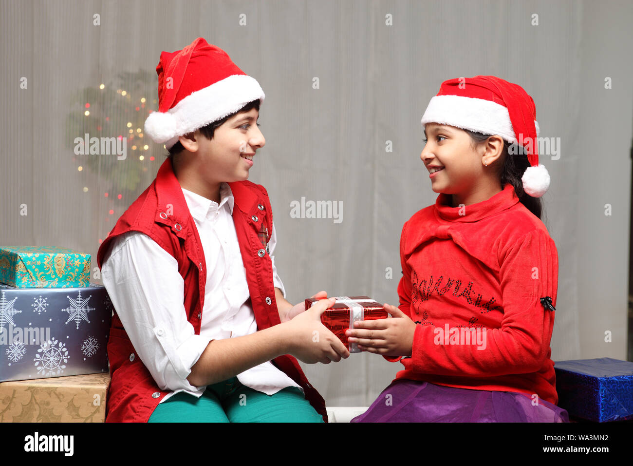Two children celebrating Christmas Stock Photo - Alamy