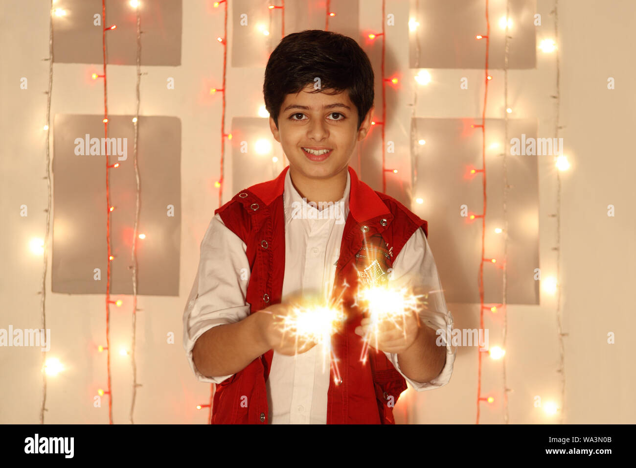 Boy burning phooljhadi on Diwali Stock Photo - Alamy