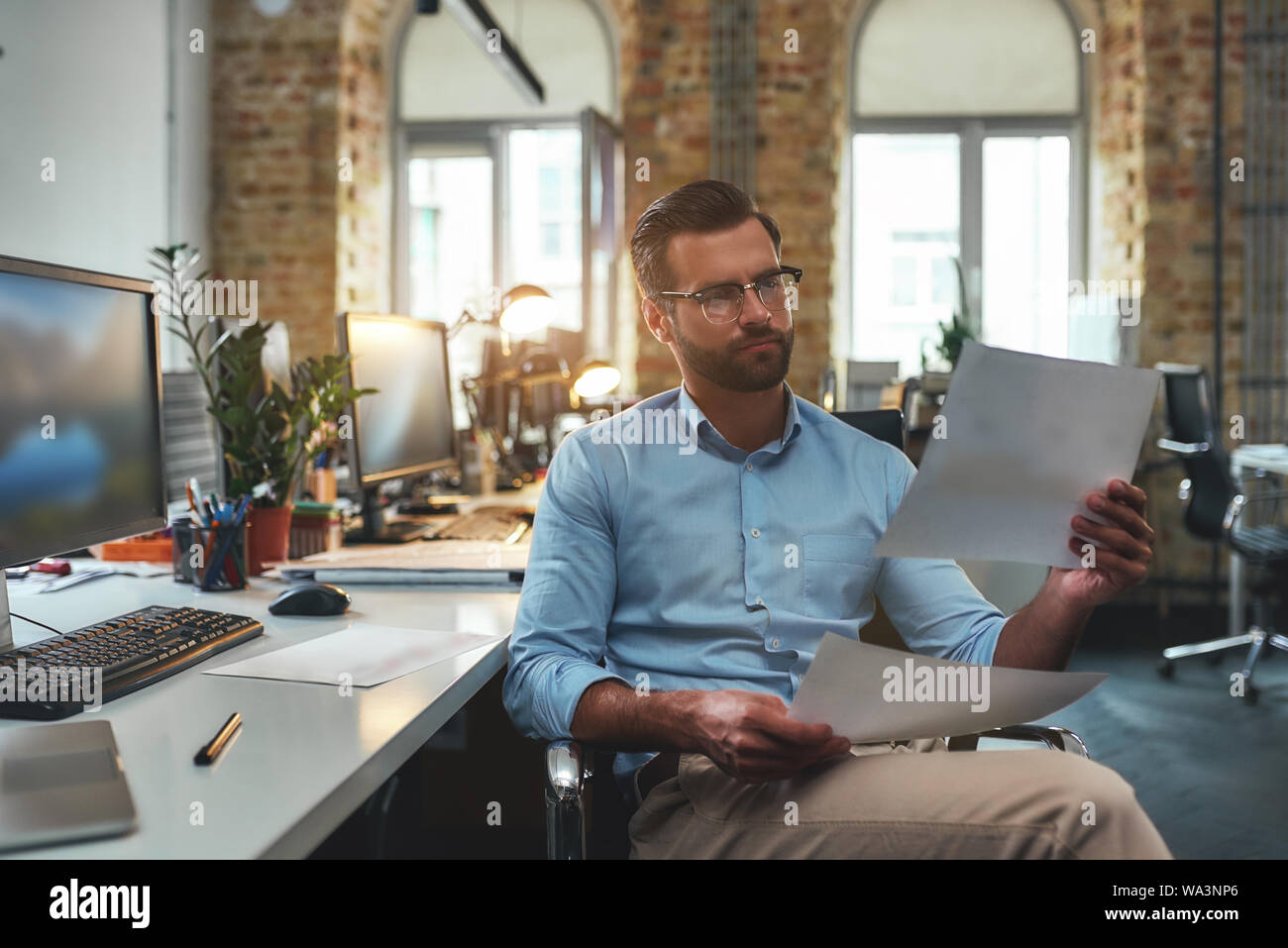 Working Hard Concentrated Bearded Man In Eyeglasses And Formal Wear