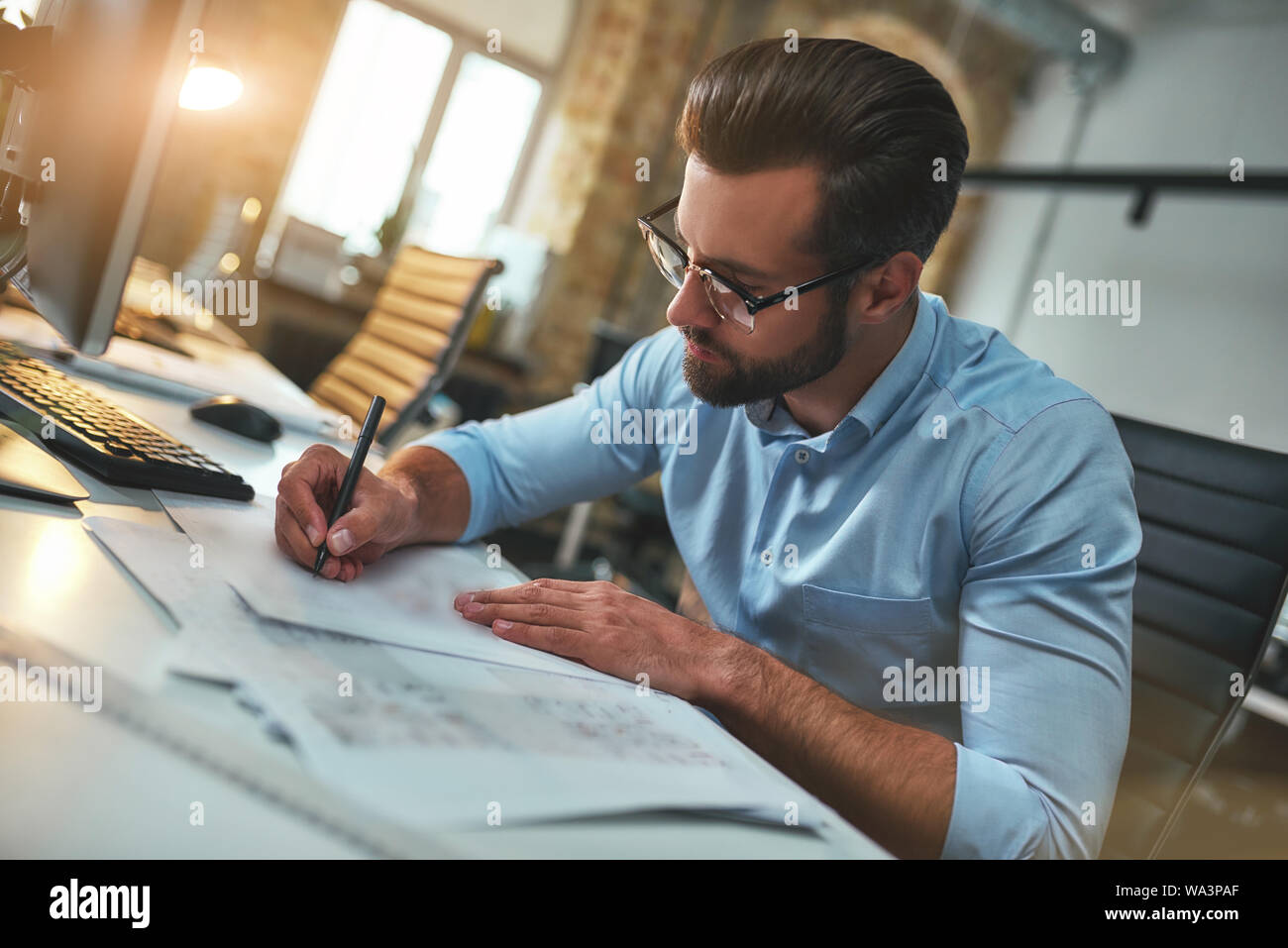 New project. Busy bearded engineer in eyeglasses and formal wear ...
