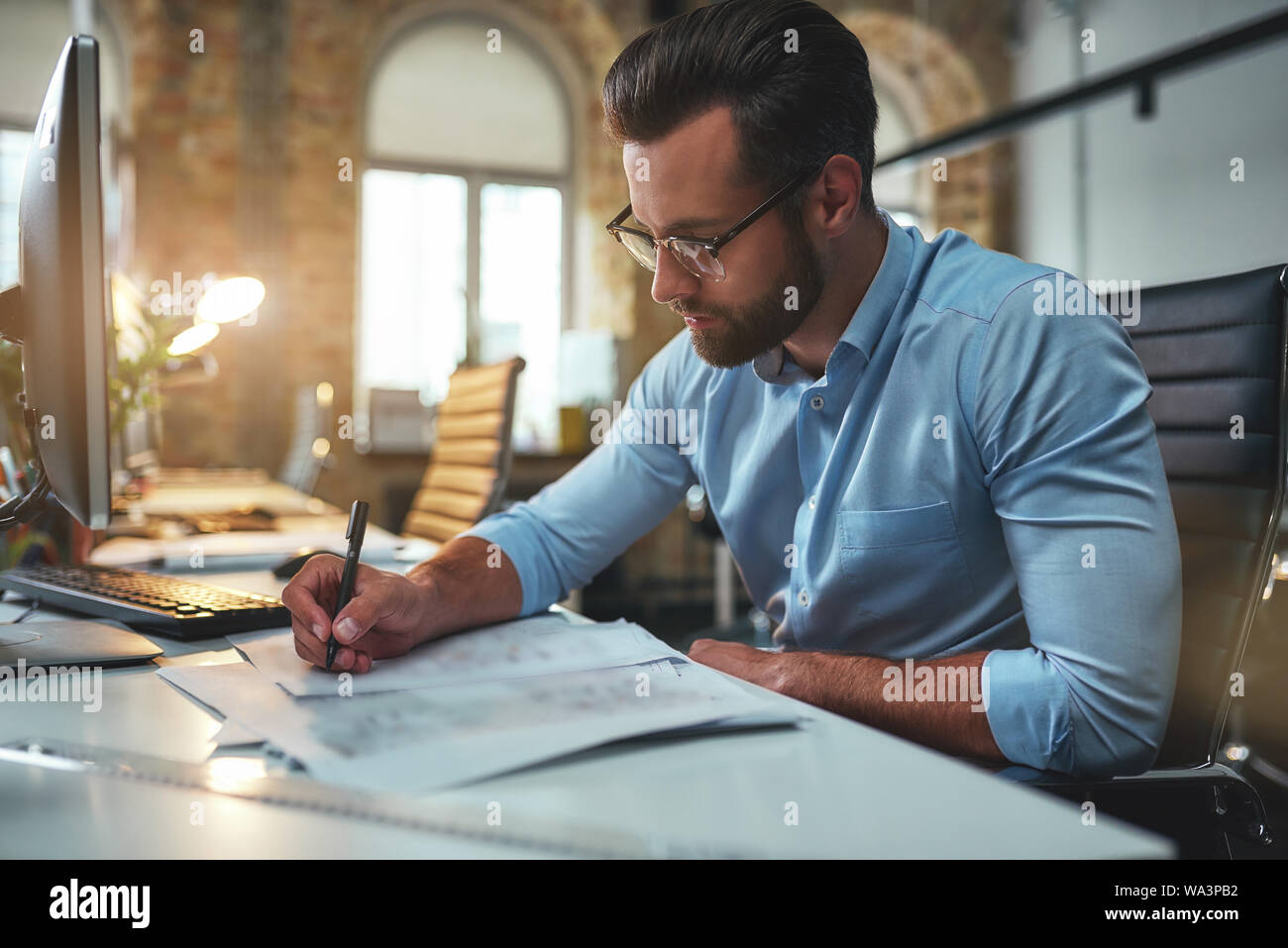 Young engineer. Successful busy bearded man in eyeglasses and formal ...