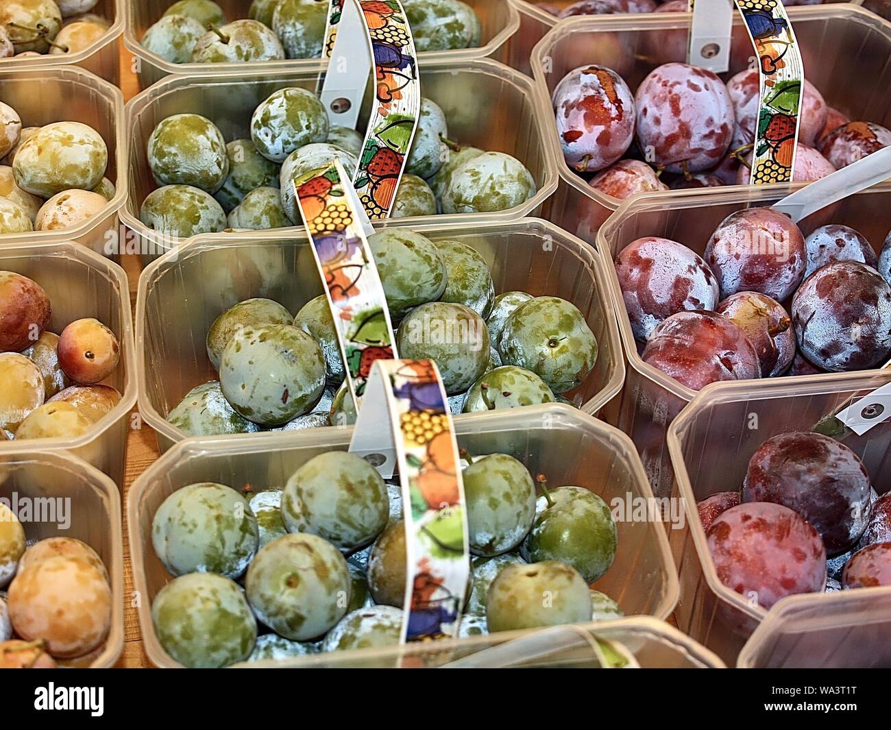 colorful ripe plums on a pile in boxes Stock Photo - Alamy