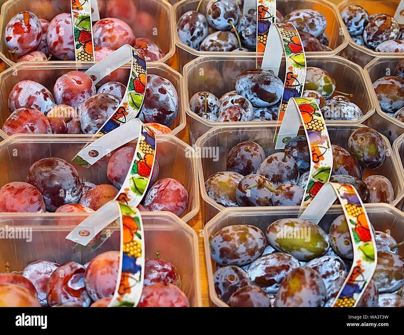 colorful ripe plums on a pile in boxes Stock Photo - Alamy