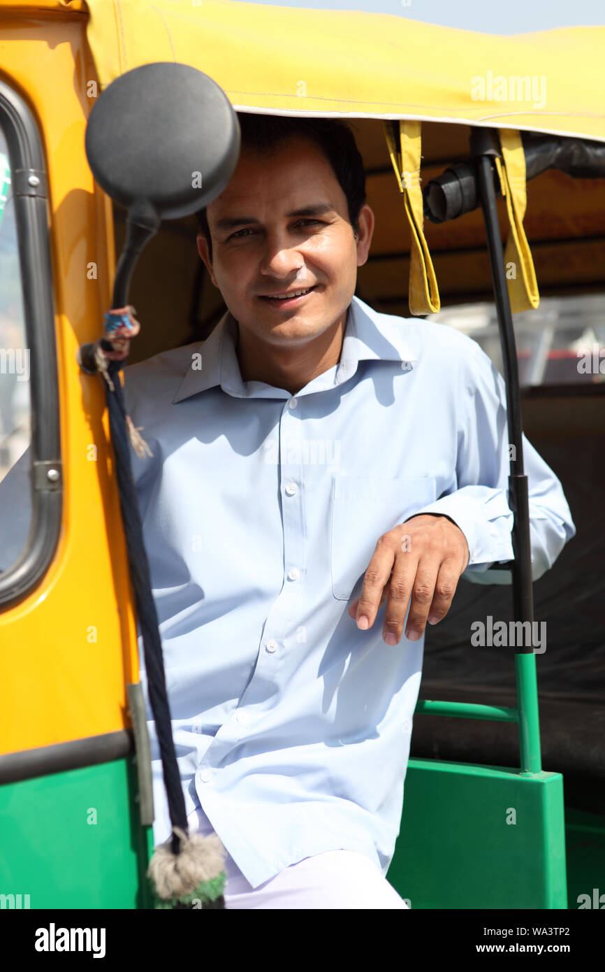 Auto driver sitting in an auto rickshaw and smiling Stock Photo - Alamy