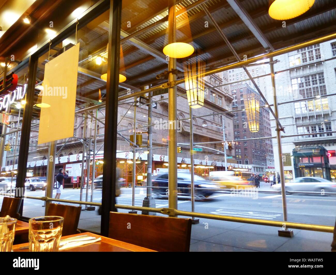 shot of the inside of a cafe with glass windows with the view of the ...
