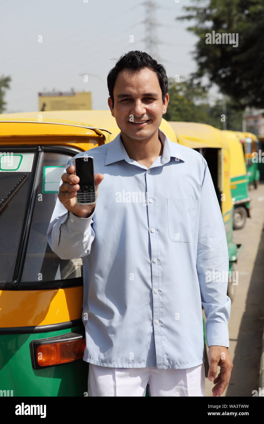 Auto driver showing a mobile phone Stock Photo - Alamy