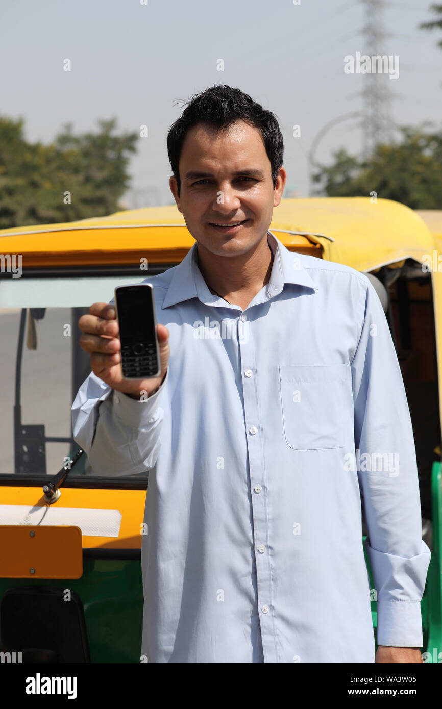Auto driver showing a mobile phone Stock Photo - Alamy
