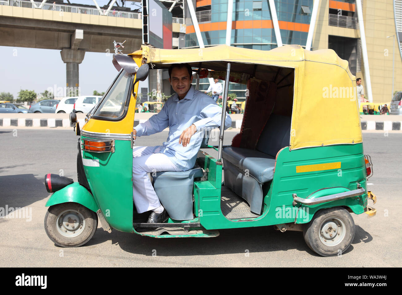 Auto driver sitting in an auto rickshaw Stock Photo - Alamy