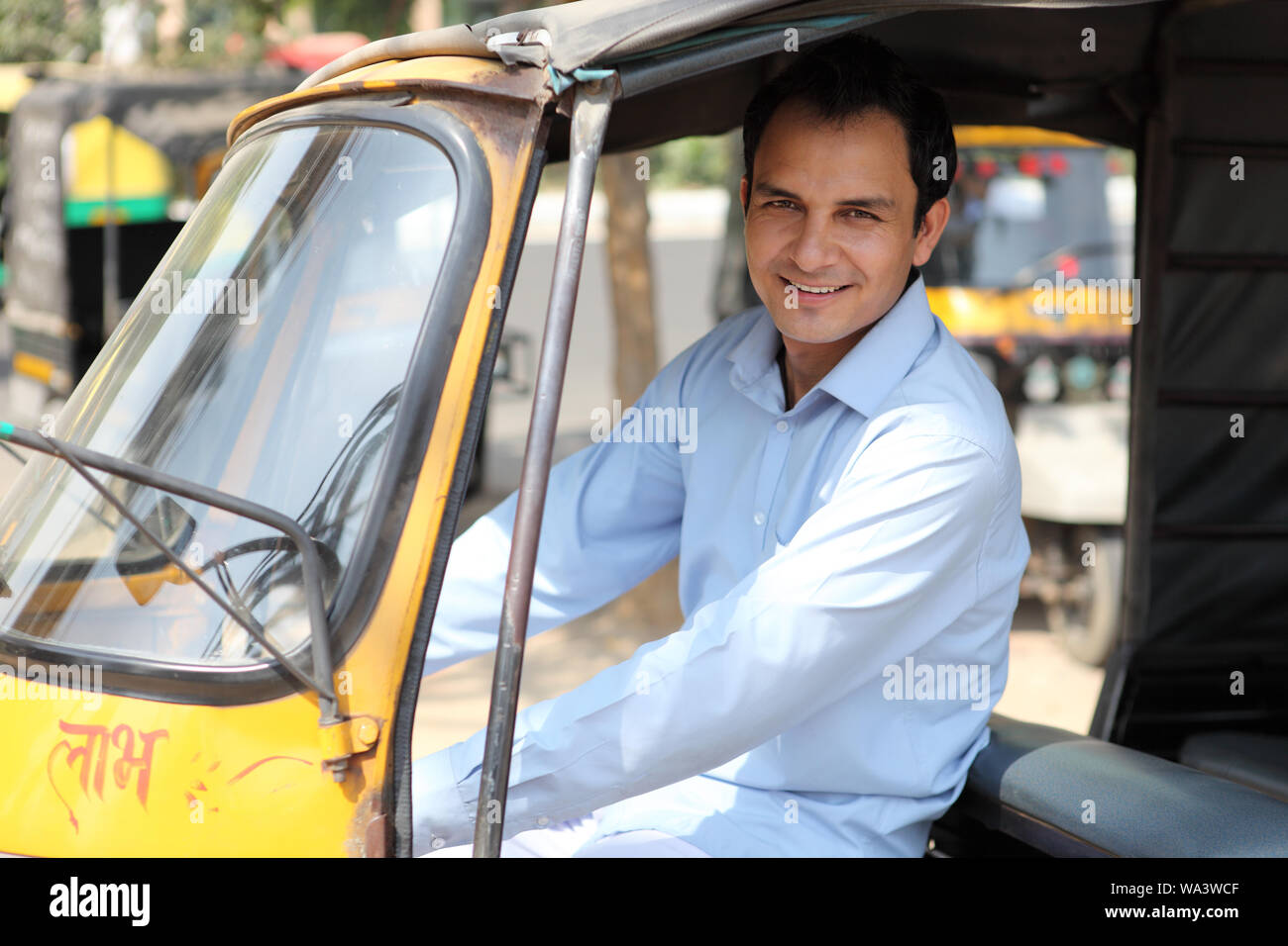 Auto driver driving an auto rickshaw Stock Photo - Alamy