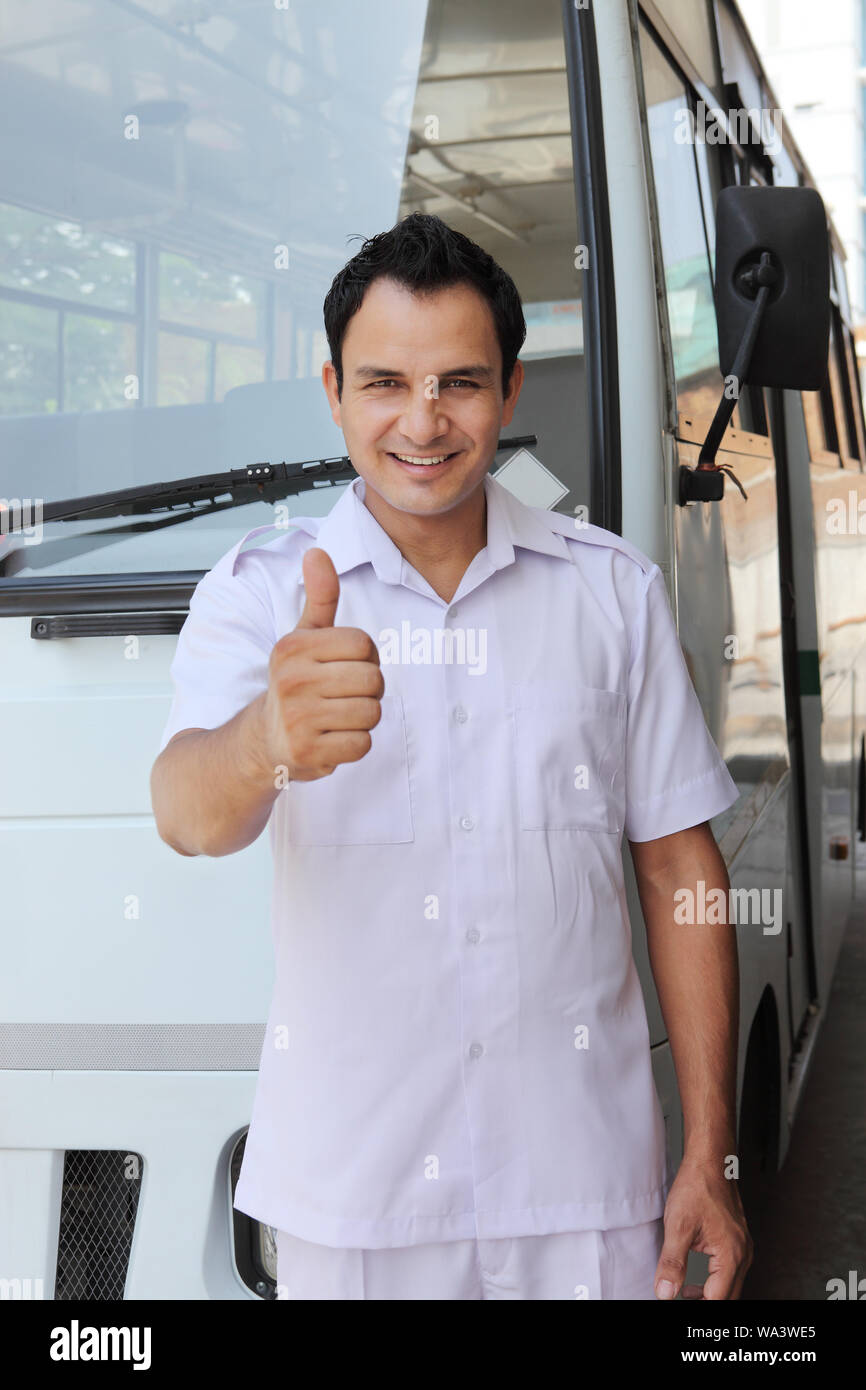 Bus driver standing with his bus and showing thumbs up sign Stock Photo ...
