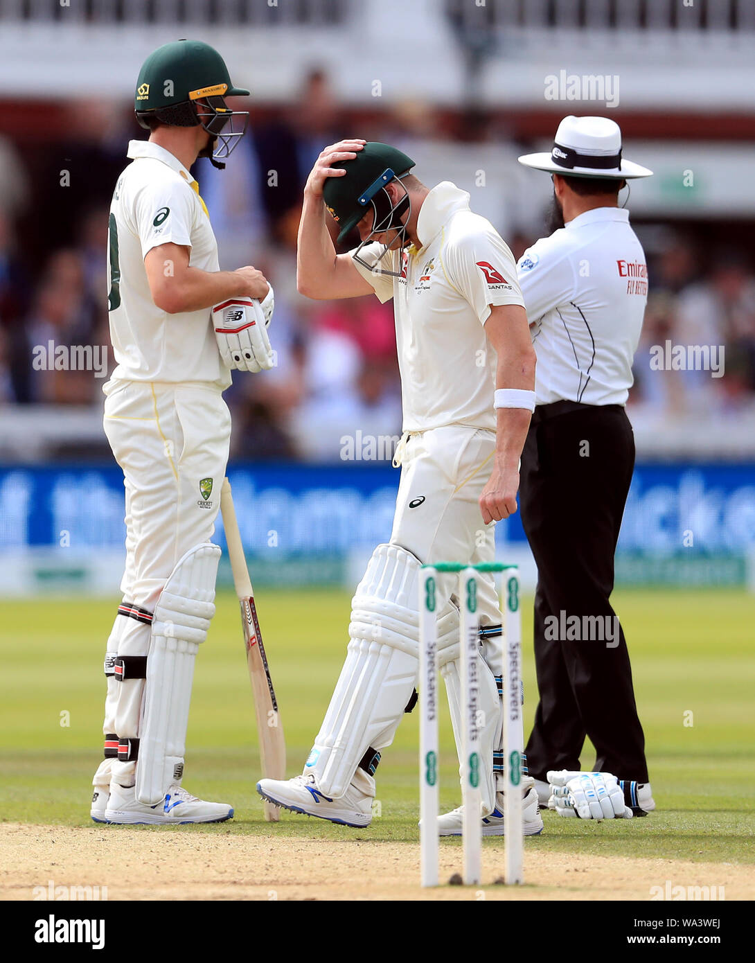Australia's Steve Smith reacts after being hit by the ball during day ...