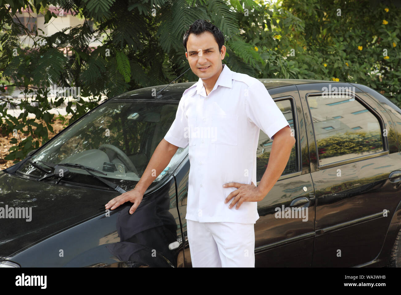 Car driver standing with his car Stock Photo - Alamy