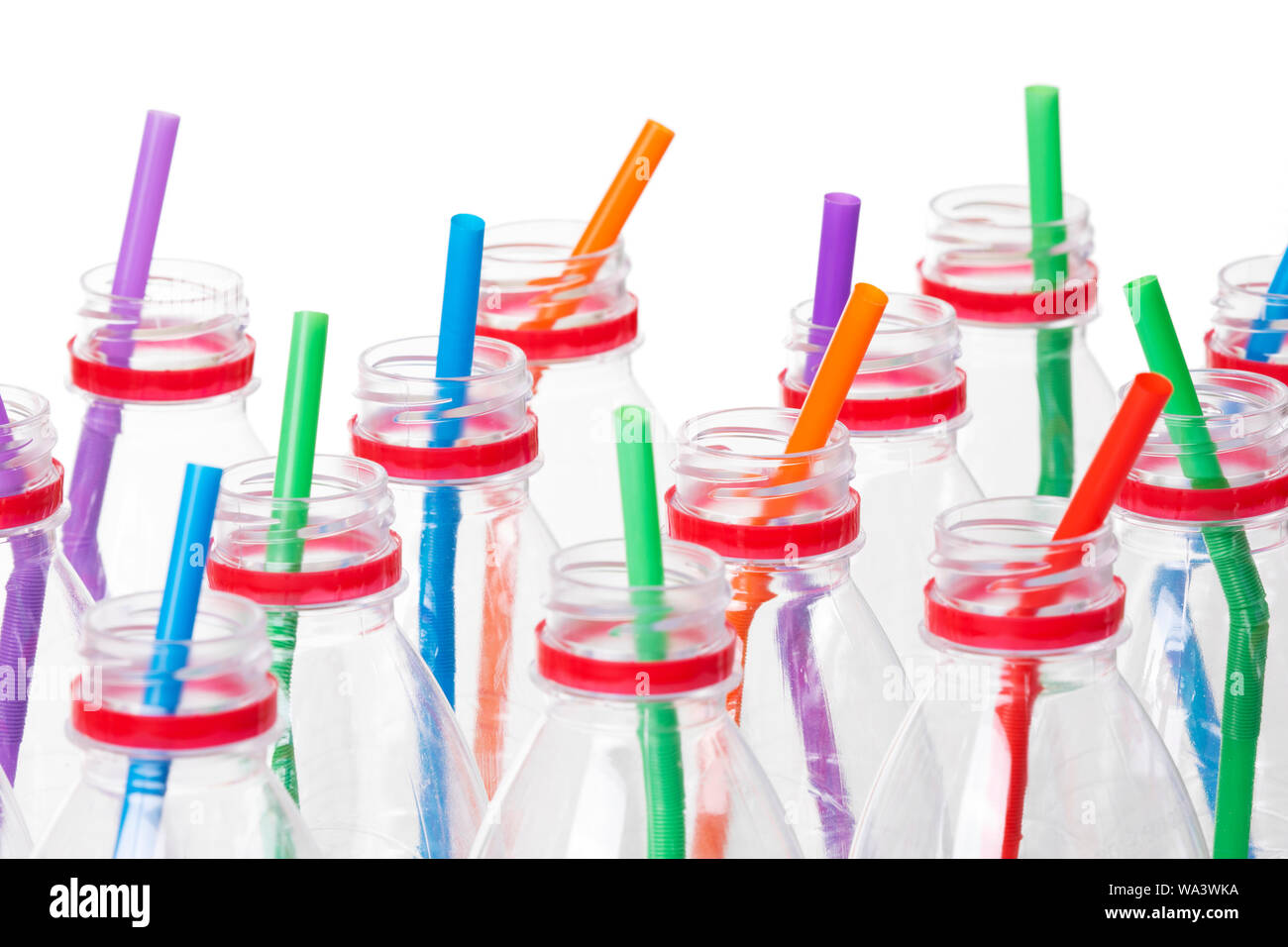 A collection of clear plastic bottles with straws isolated on a white ...