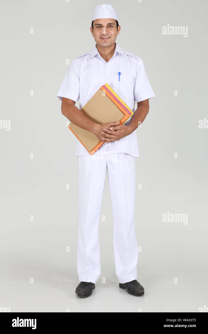 Peon holding files in office Stock Photo - Alamy