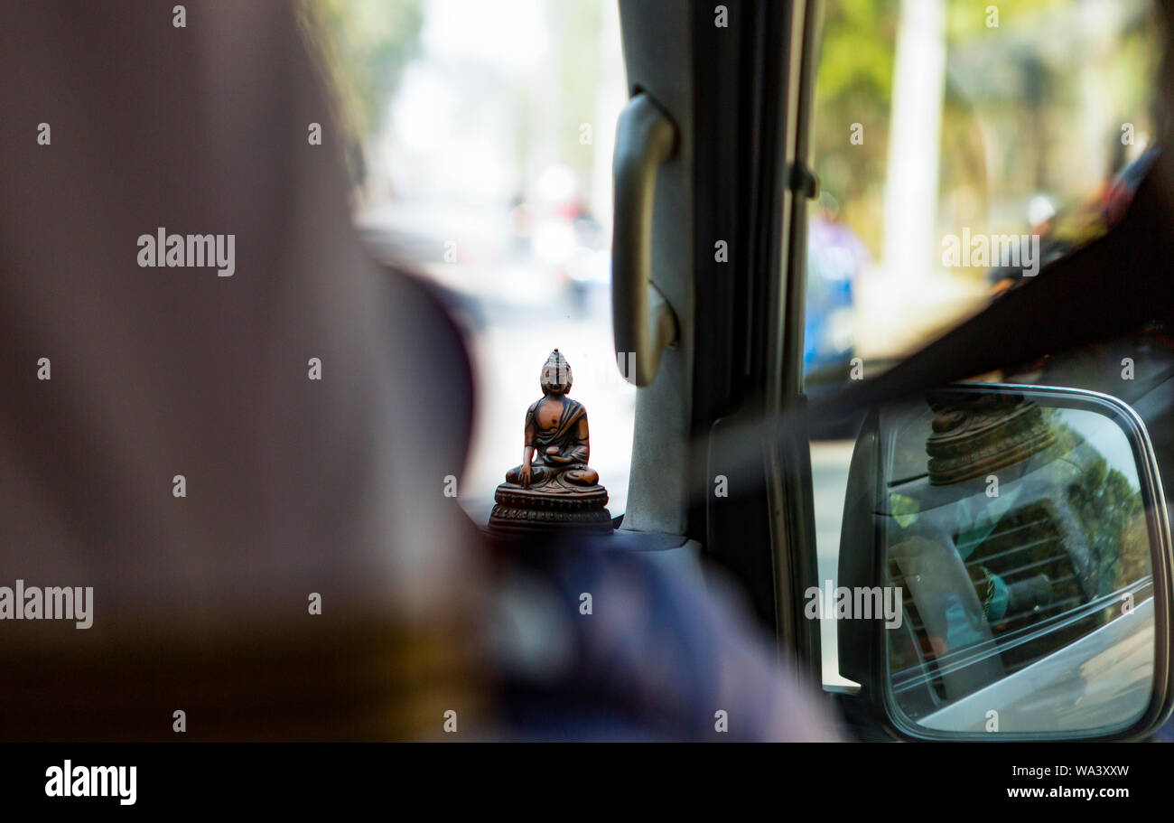small metallic buddha statue in a car for good luck in traffic Stock ...