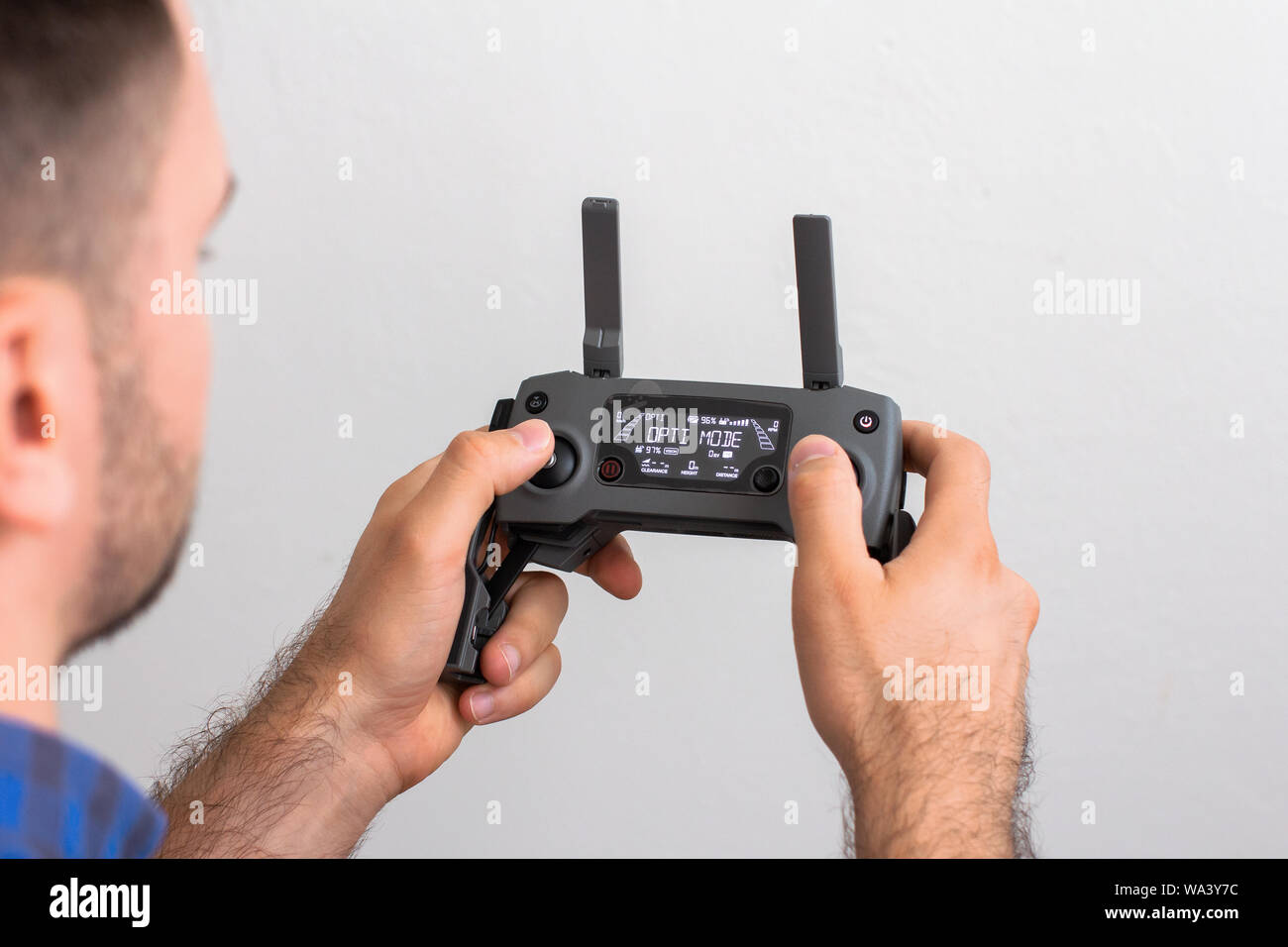 Hands with remote controller of drone outside. Man using RC for flying ...