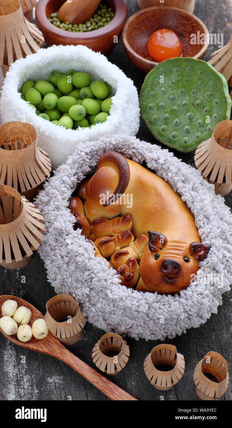 Top view of moon cake mother pig and piglets, baking materials, paper ...