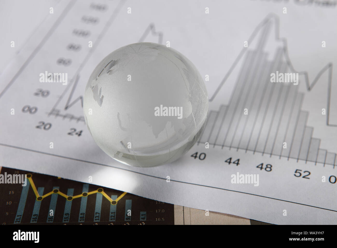 Close up of a globe with bar graphs Stock Photo - Alamy