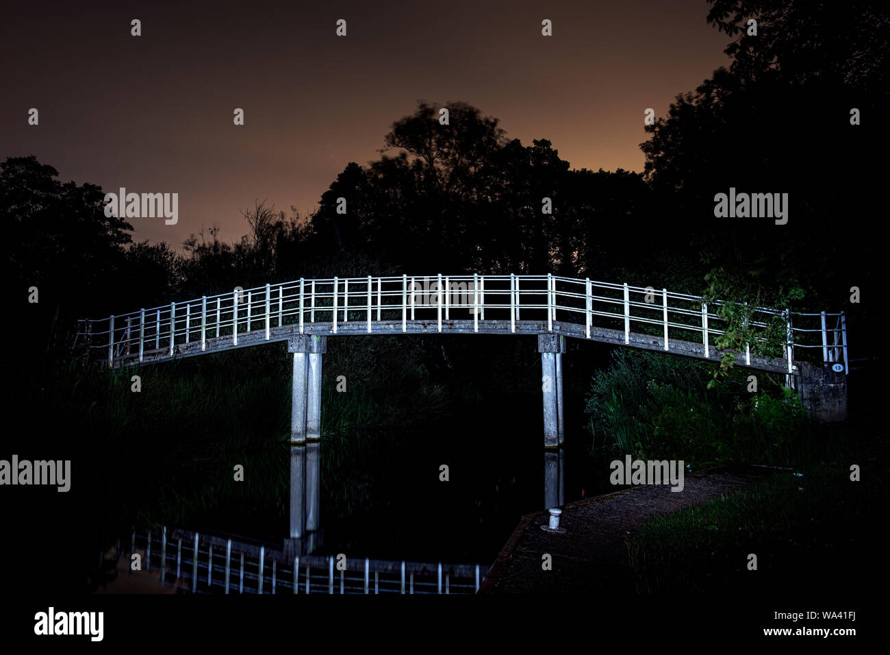Canal footbridge at night, illuminated by torchlight Stock Photo - Alamy