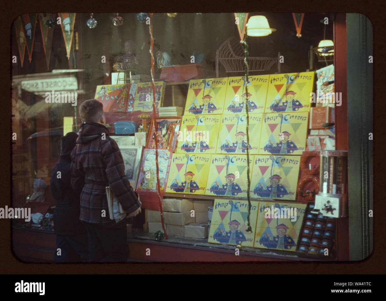 Boy looking at store window display of toys Stock Photo - Alamy