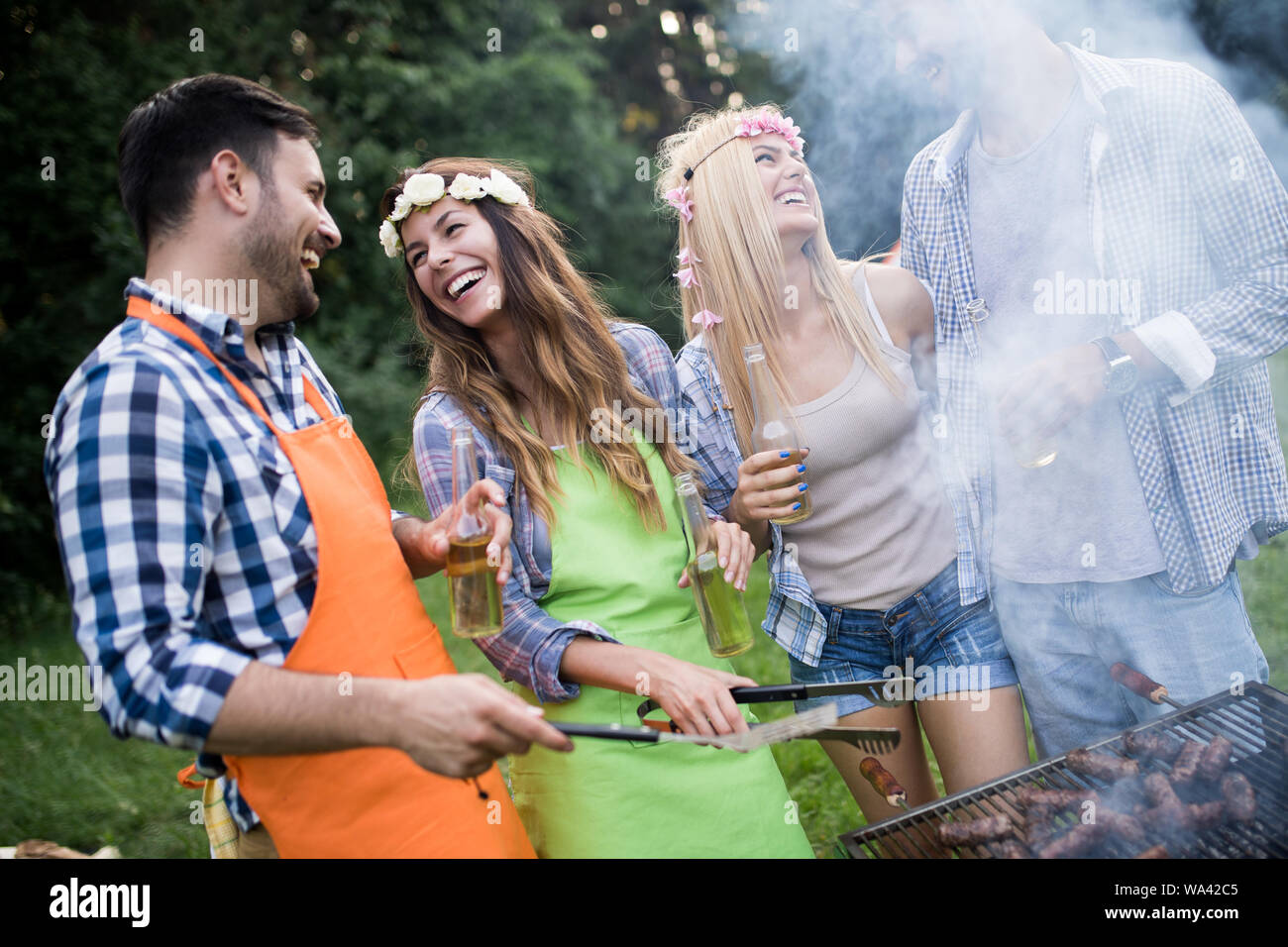 Group of friends having fun in nature doing bbq Stock Photo - Alamy