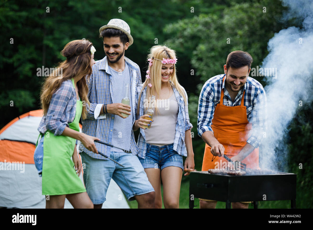 Group of friends having fun in nature doing bbq Stock Photo - Alamy
