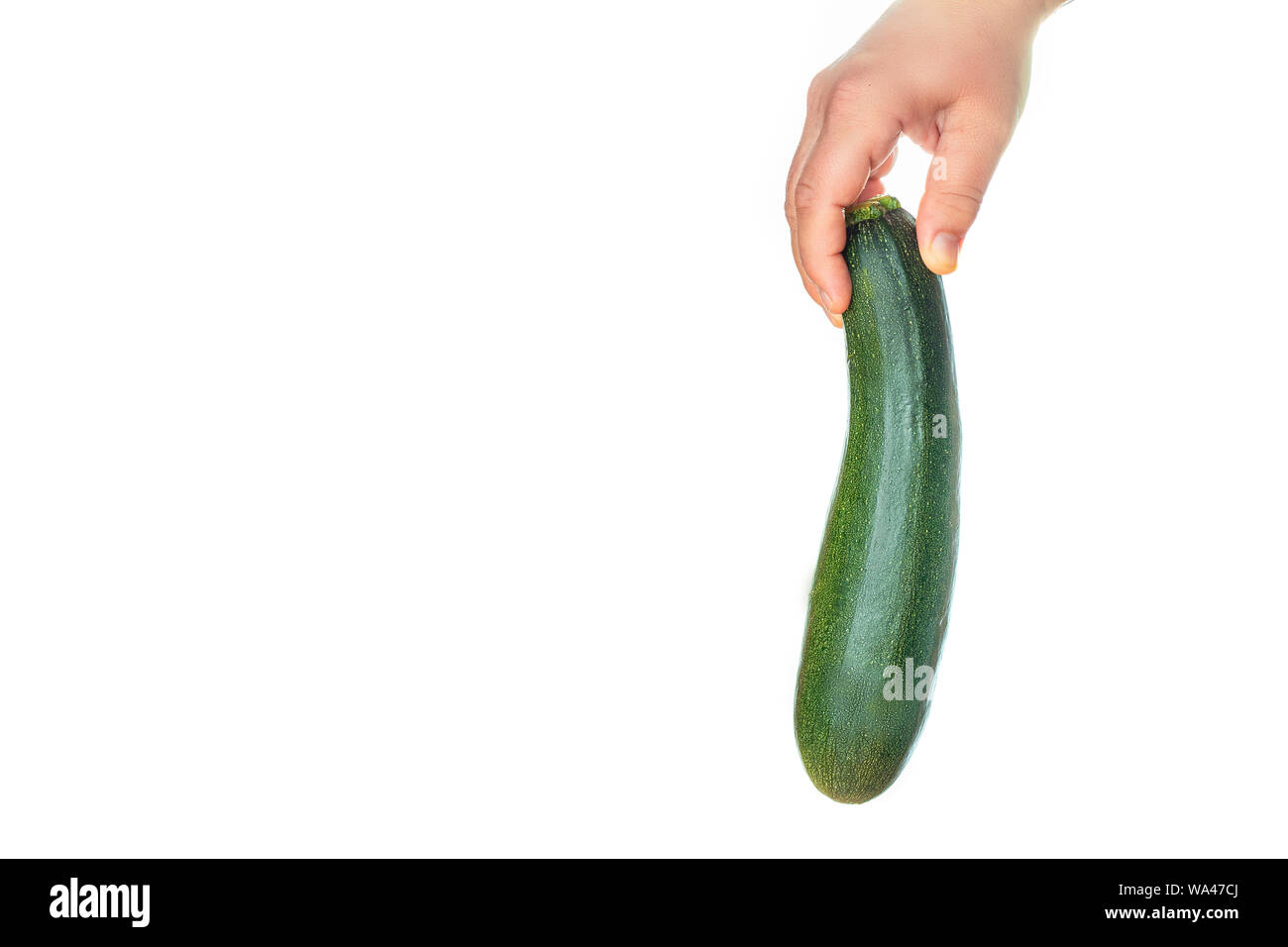 Hand with zucchini on a white background. Woman with zucchini in hand ...