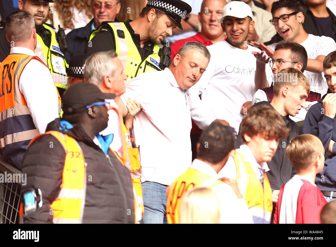 A fan being escorted out crowd hi-res stock photography and images - Alamy