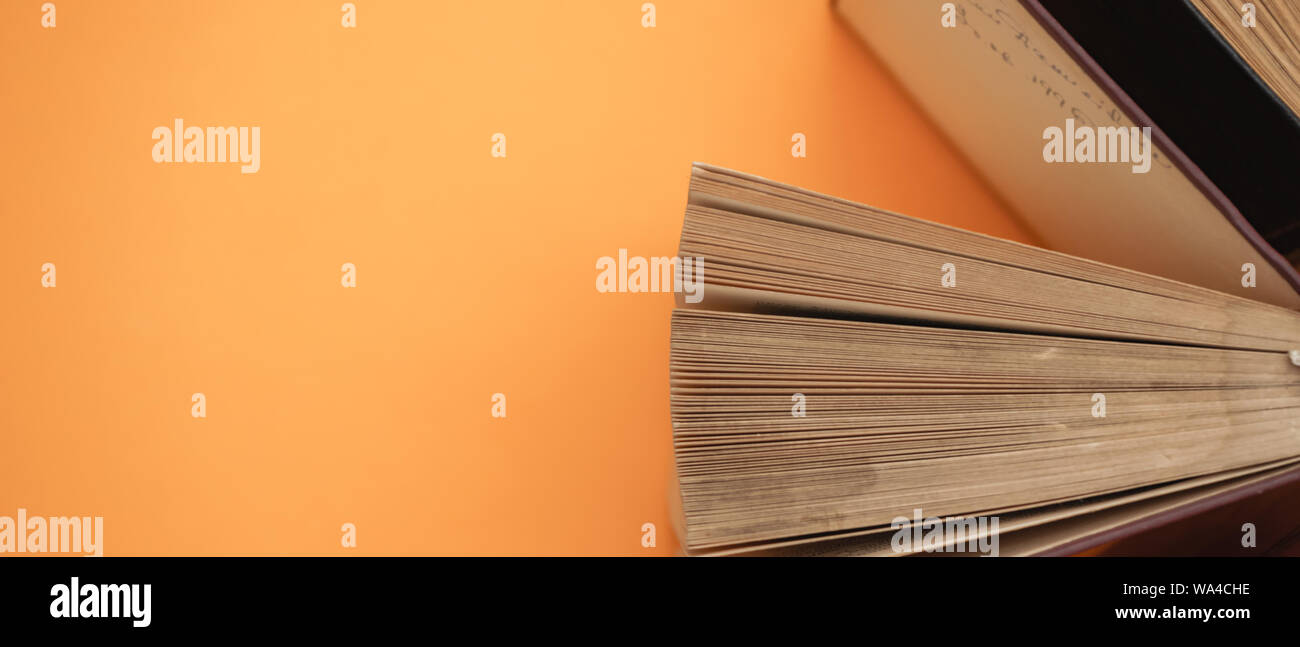 Open book on a yellow background. Top view Stock Photo - Alamy