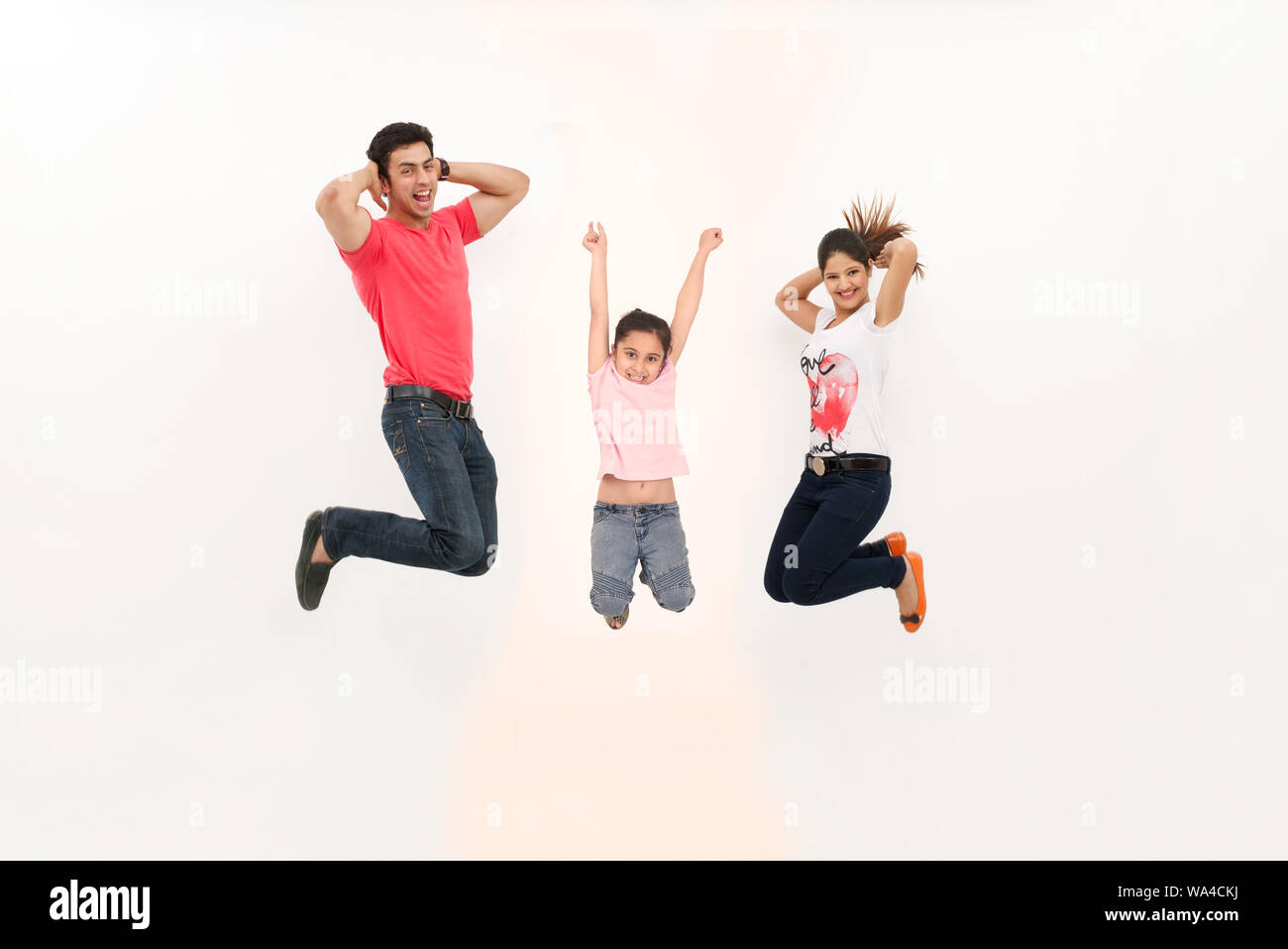 Young family jumping in air Stock Photo - Alamy