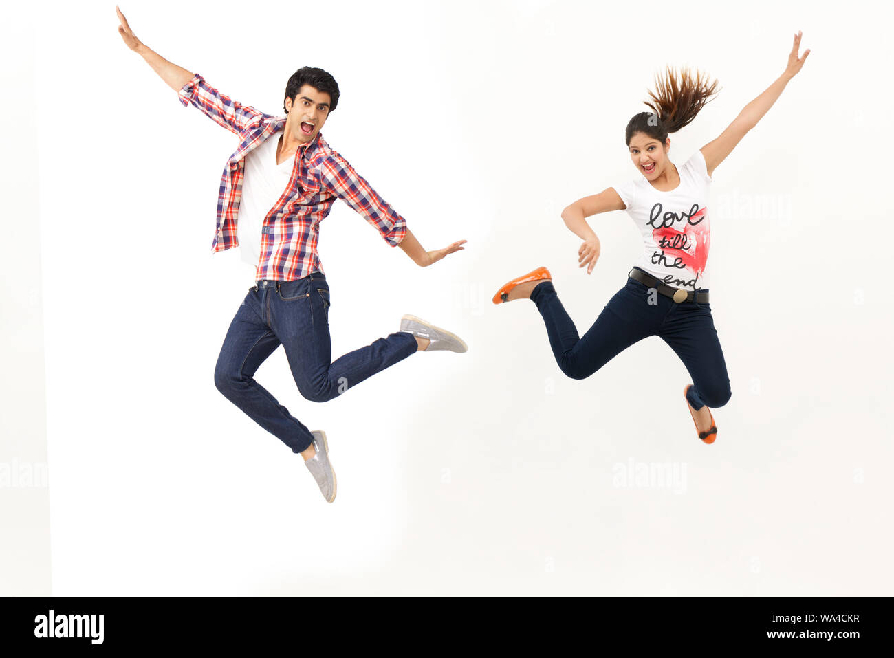 Young couple jumping in air Stock Photo - Alamy