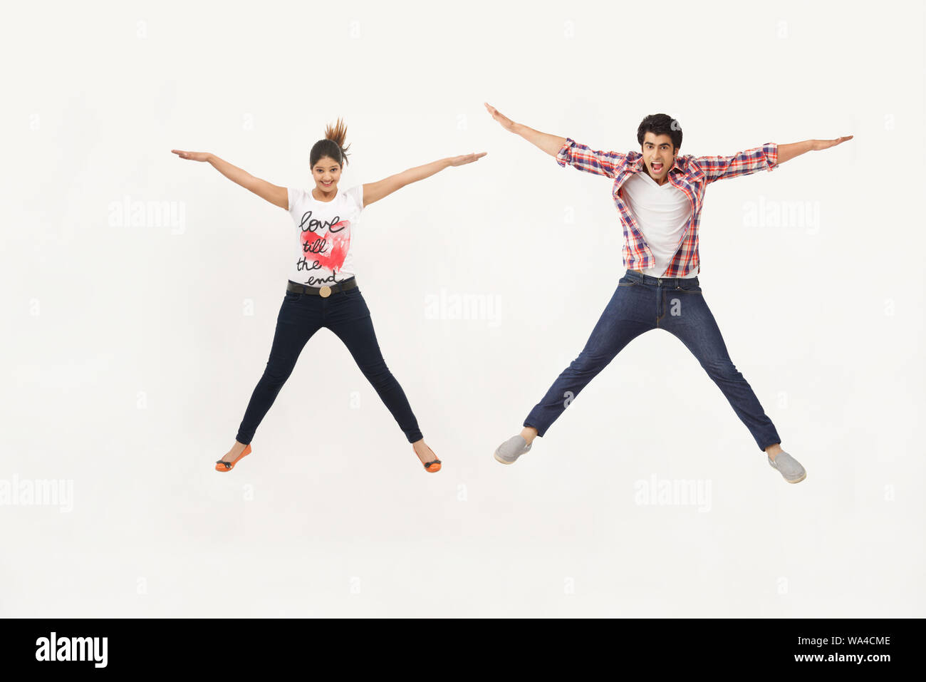 Young couple jumping in air Stock Photo - Alamy