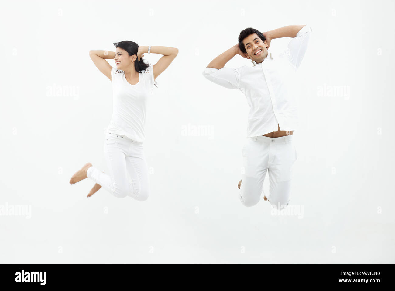 Young couple jumping in air Stock Photo - Alamy
