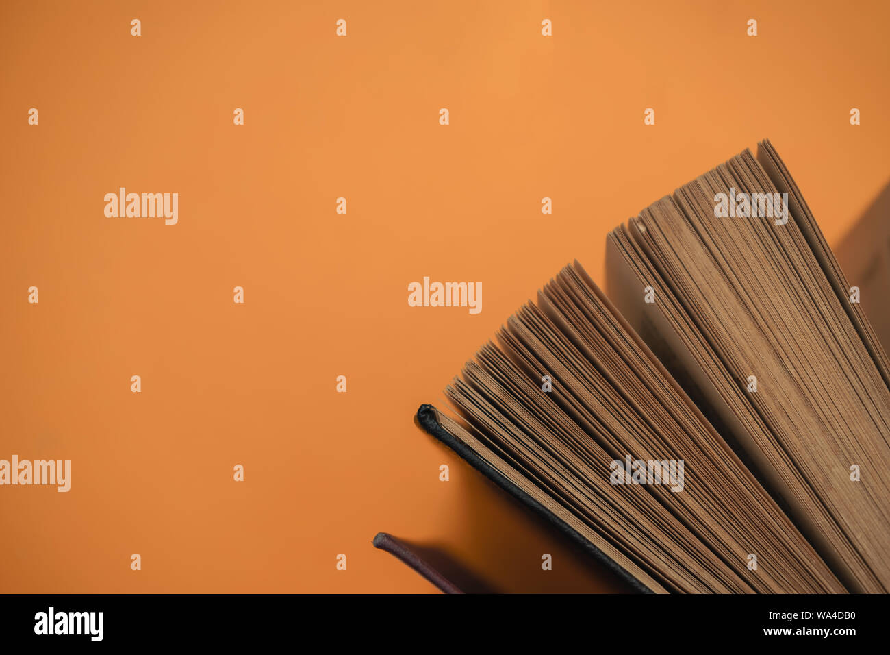 Open book on a yellow background. Top view Stock Photo - Alamy