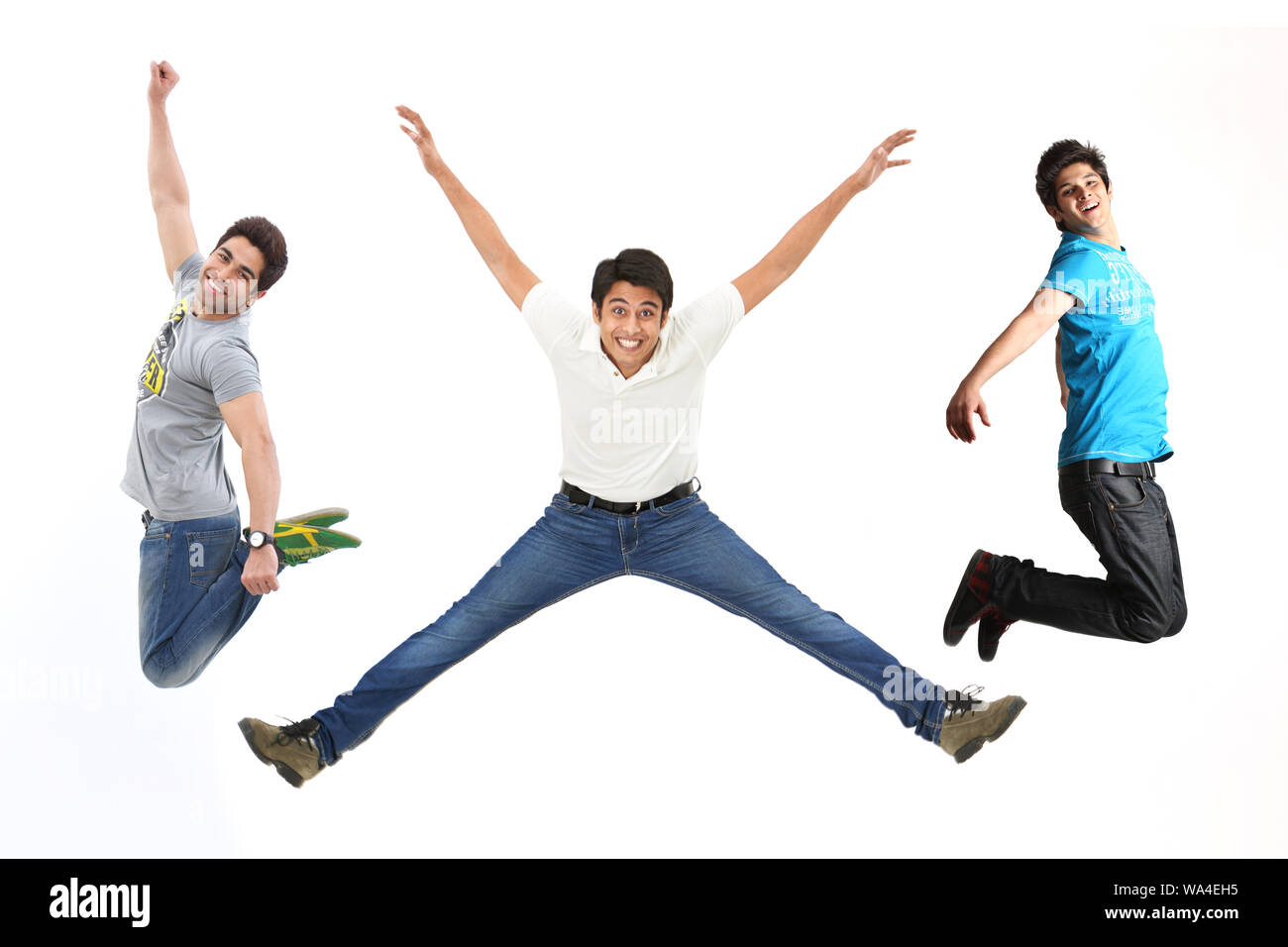 Young men jumping in air and smiling Stock Photo - Alamy