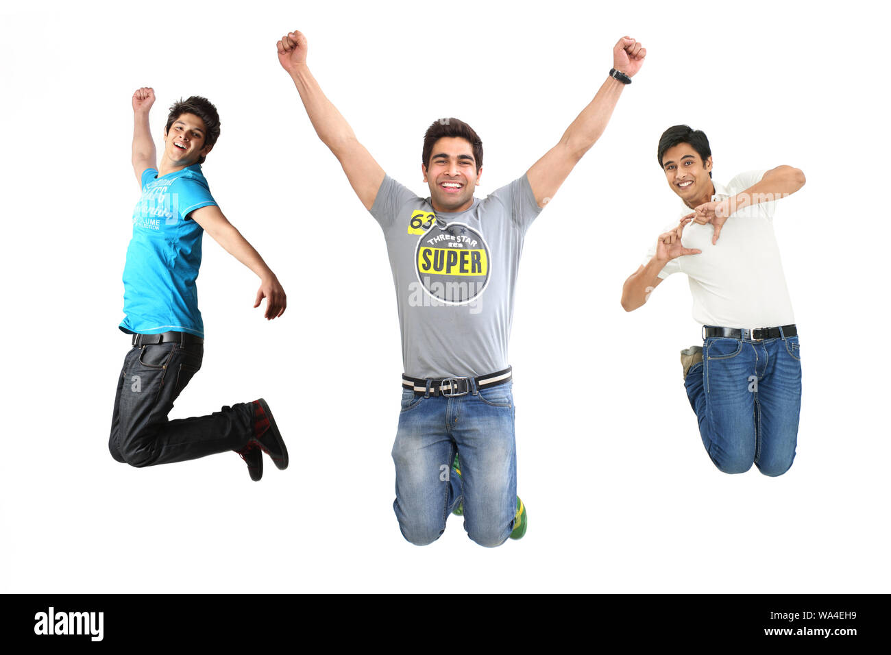Young men jumping in air and smiling Stock Photo - Alamy