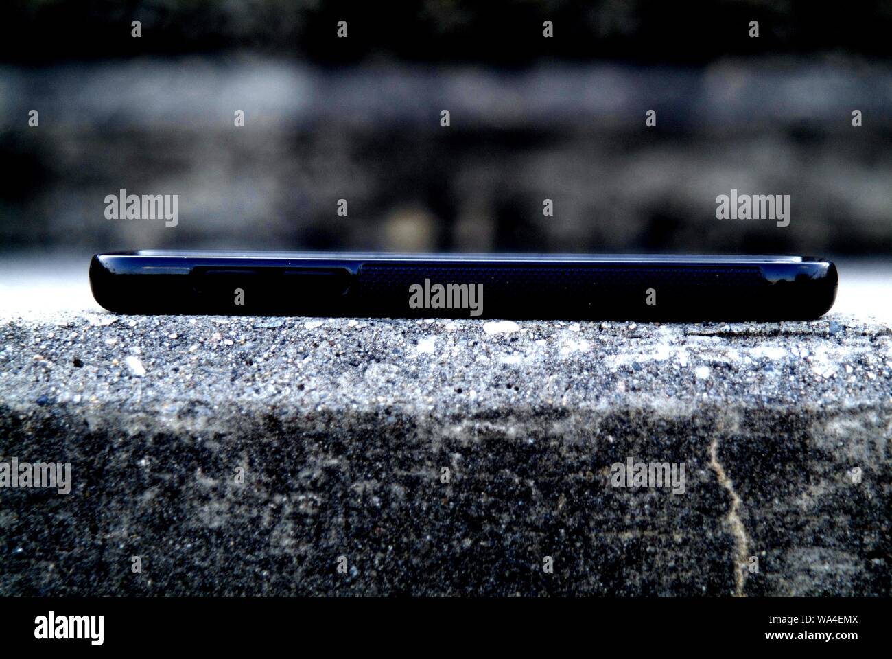 MONOLITH: A cellphone sits in profile on a stone step Stock Photo - Alamy