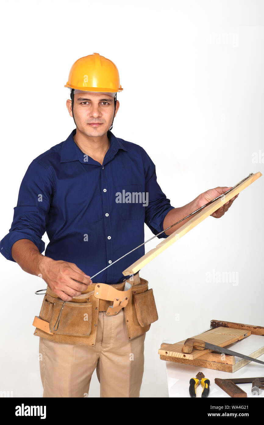 Carpenter measuring piece of wood Stock Photo - Alamy