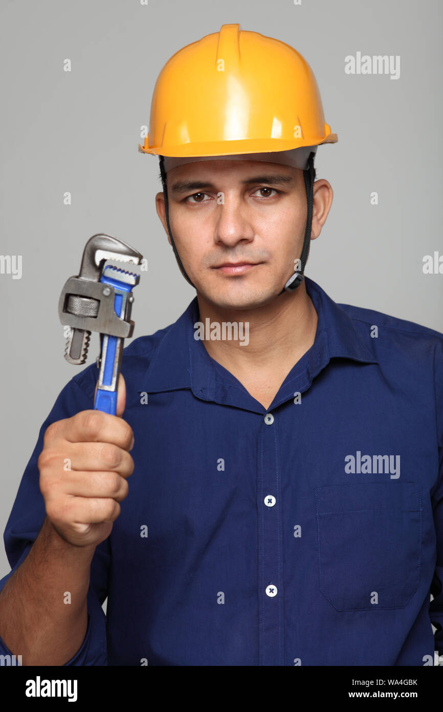 Plumber showing an adjustable wrench Stock Photo - Alamy