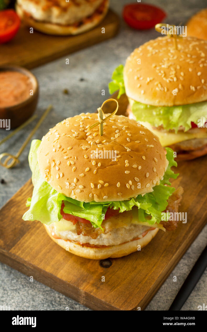 Two homemade burgers with cutlet of chicken meat, melted cheese ...